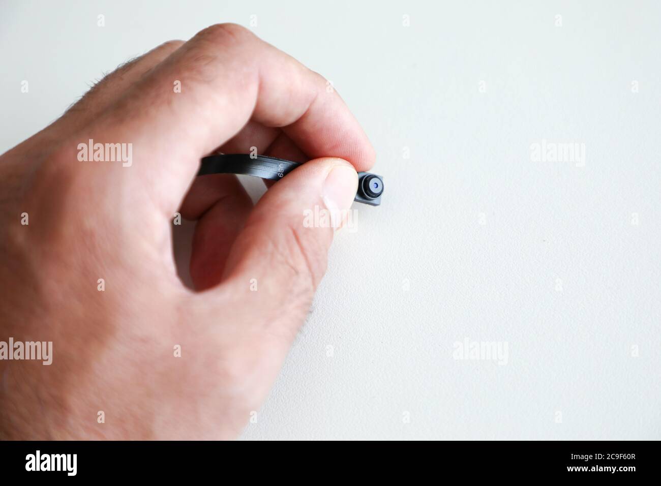 July 31, 2020: a micro camera is held between the fingers of one hand ...