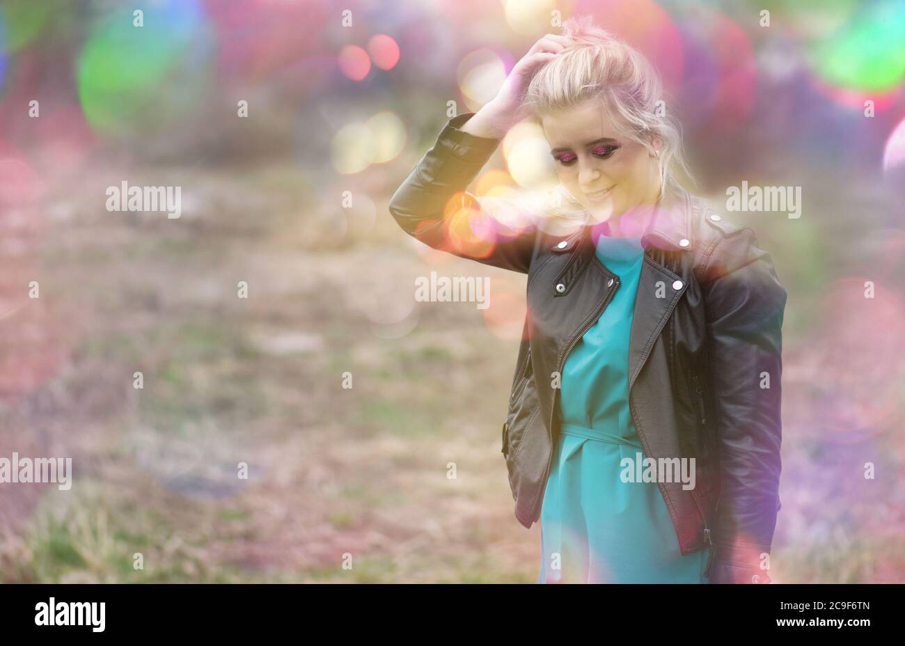 Beautiful girl with sparkles lights on her face. Happy emotional woman ...