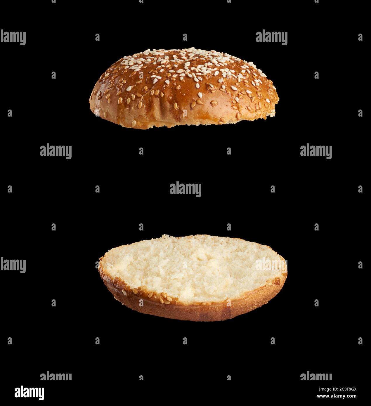 baked sesame seed round bun cut in half, halves fried and levitating in ...