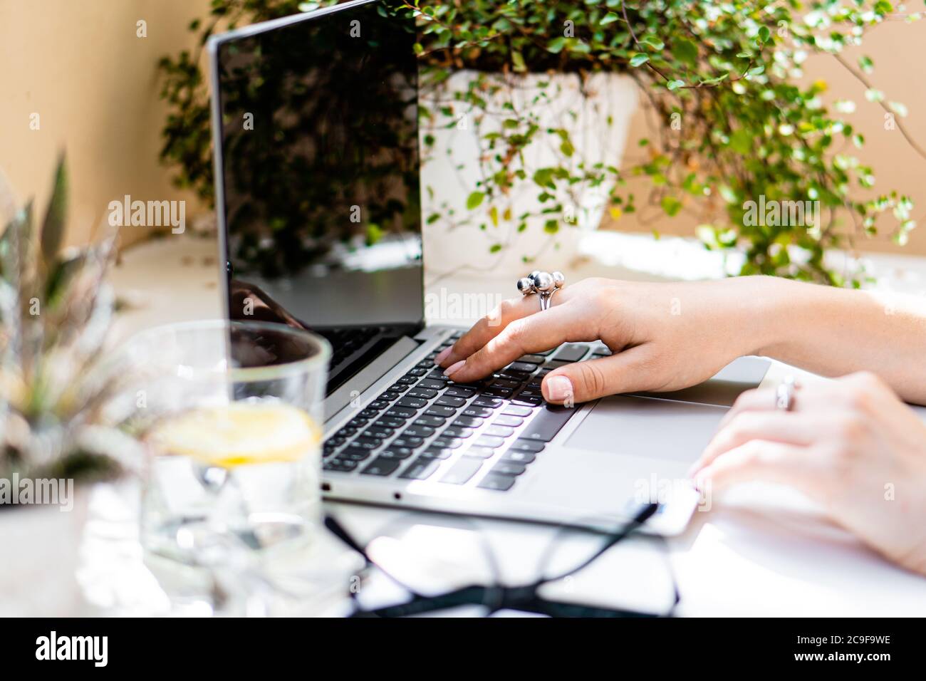 Woman's hands on laptop keyboard, cozy workplace Stock Photo - Alamy