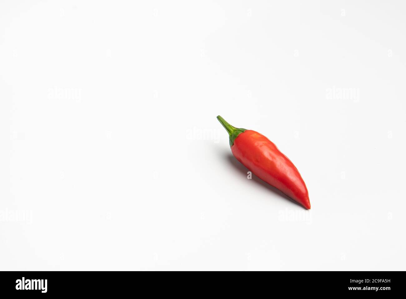 single hot red chillies on a white isolated background Stock Photo - Alamy