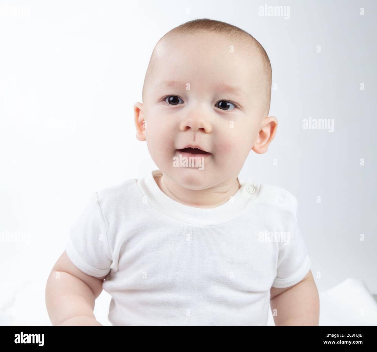 Image of a nine-month-old baby on a white background Stock Photo - Alamy