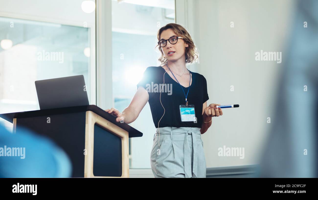 Female professional addressing a conference. businesswoman speaking ...