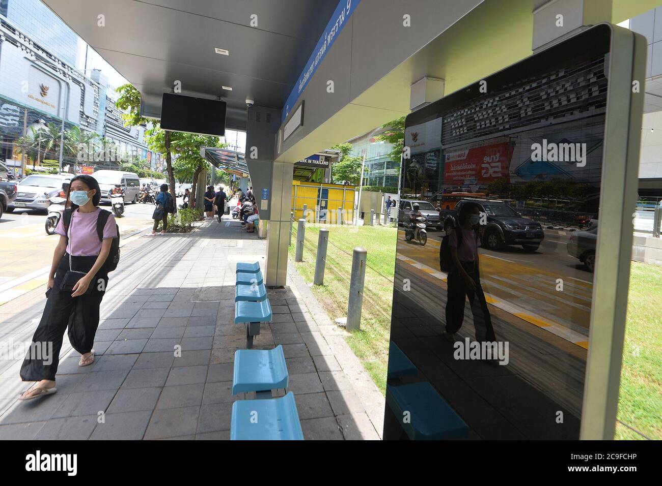 Bangkok, Thailand. 31st July, 2020. A woman walks past a smart bus stop ...