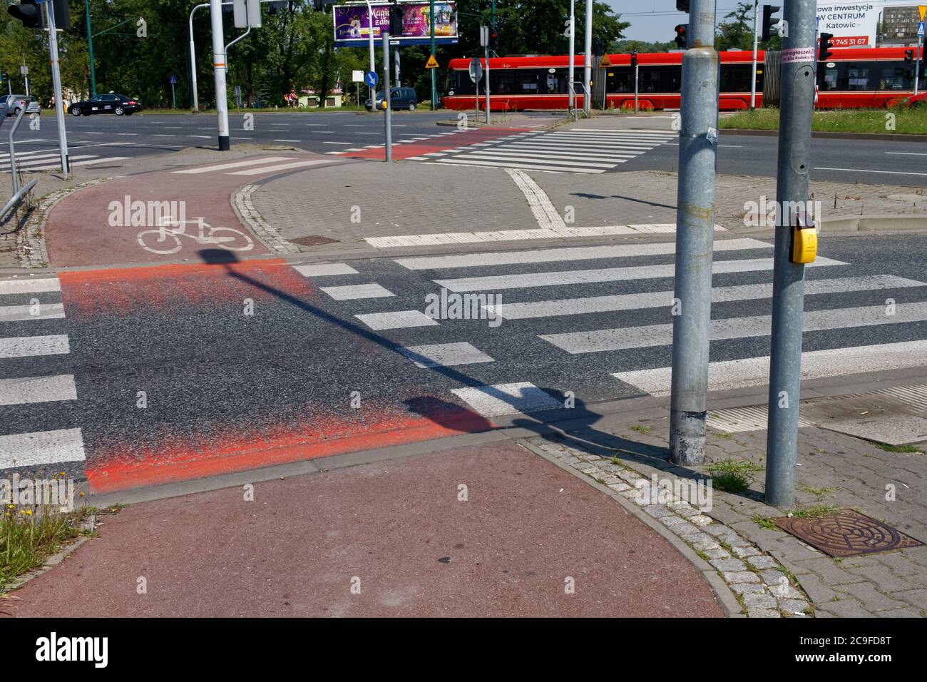 Advanced stop line and crosswalk on a busy junction. Red tram Pesa ...