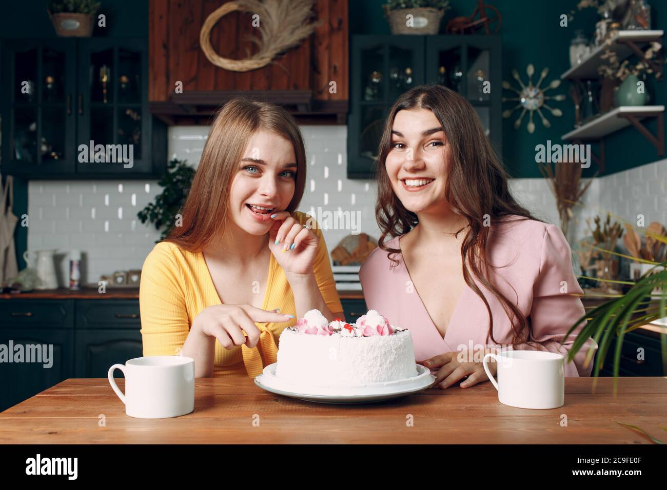Women happy friends at home sitting and smiling with white birthday ...