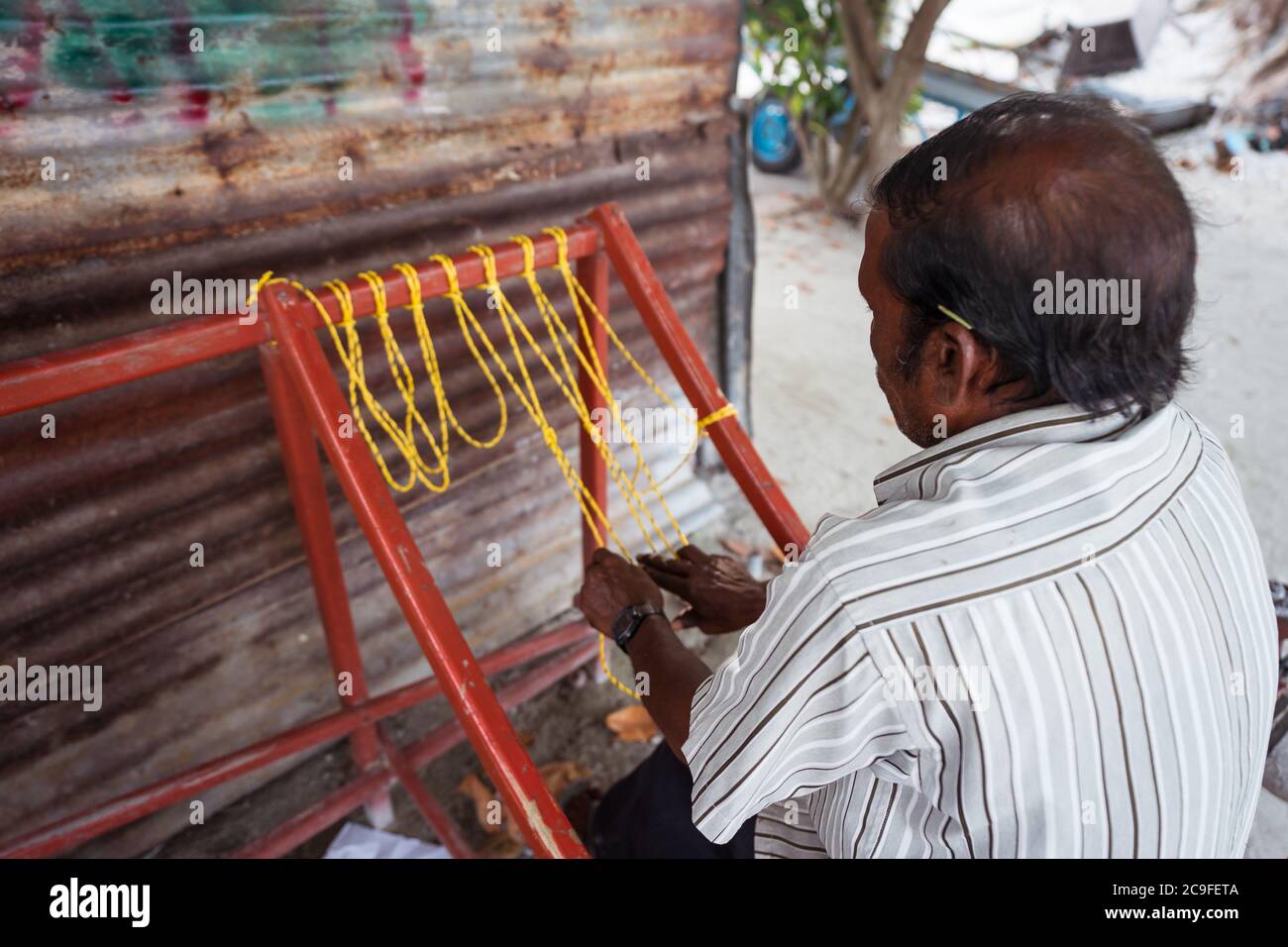 Bodufolhudhoo / Maldives - August 17, 2019: Maldivian man fixing ...