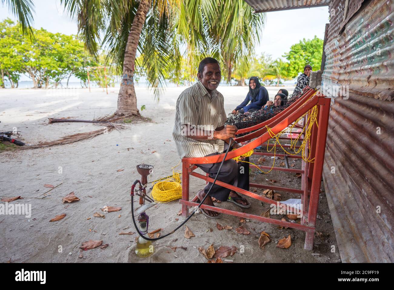 Bodufolhudhoo / Maldives - August 17, 2019: Maldivian man fixing ...