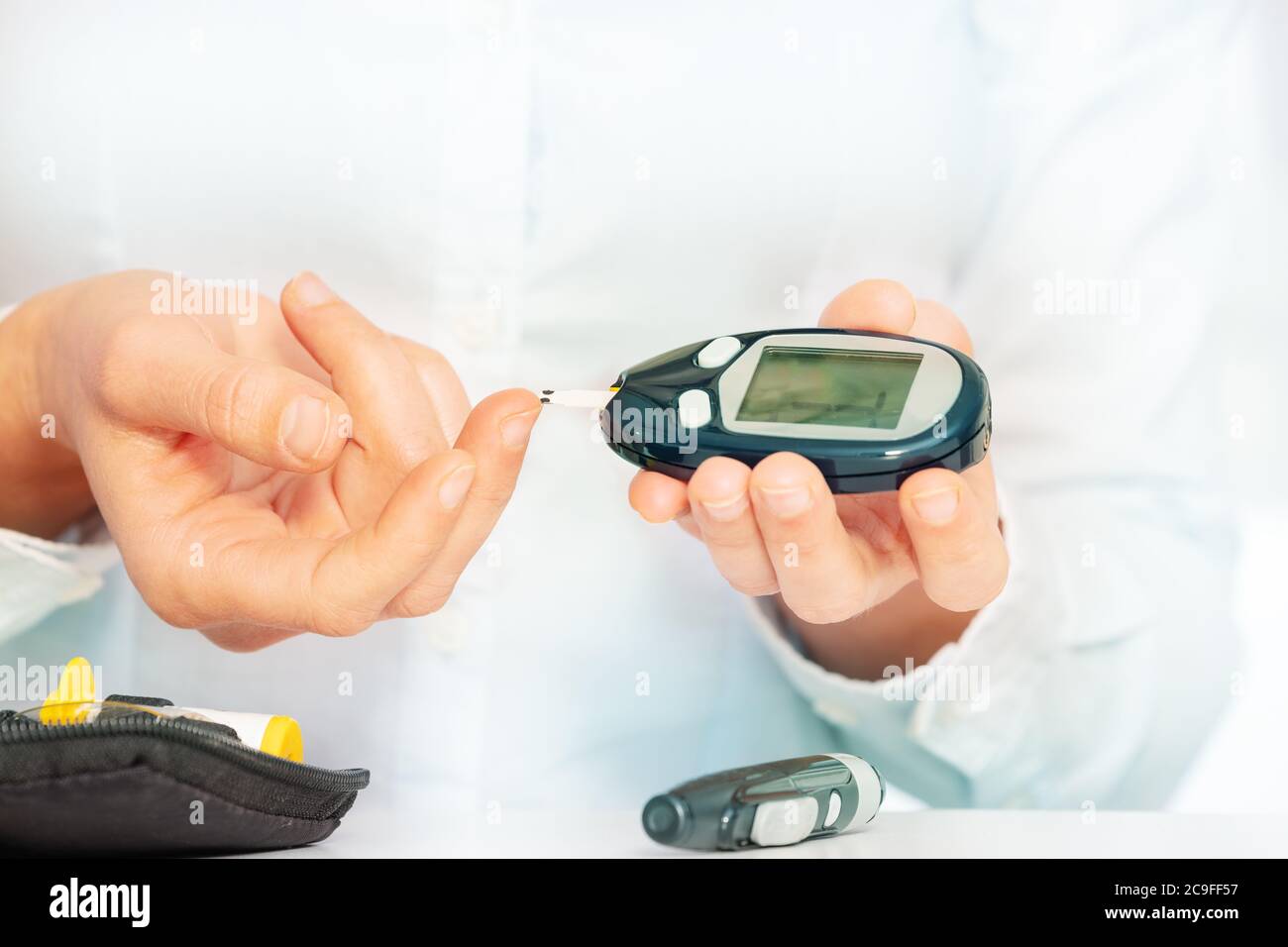 Sugar blood tester in woman hands testing for diabetes Stock Photo - Alamy