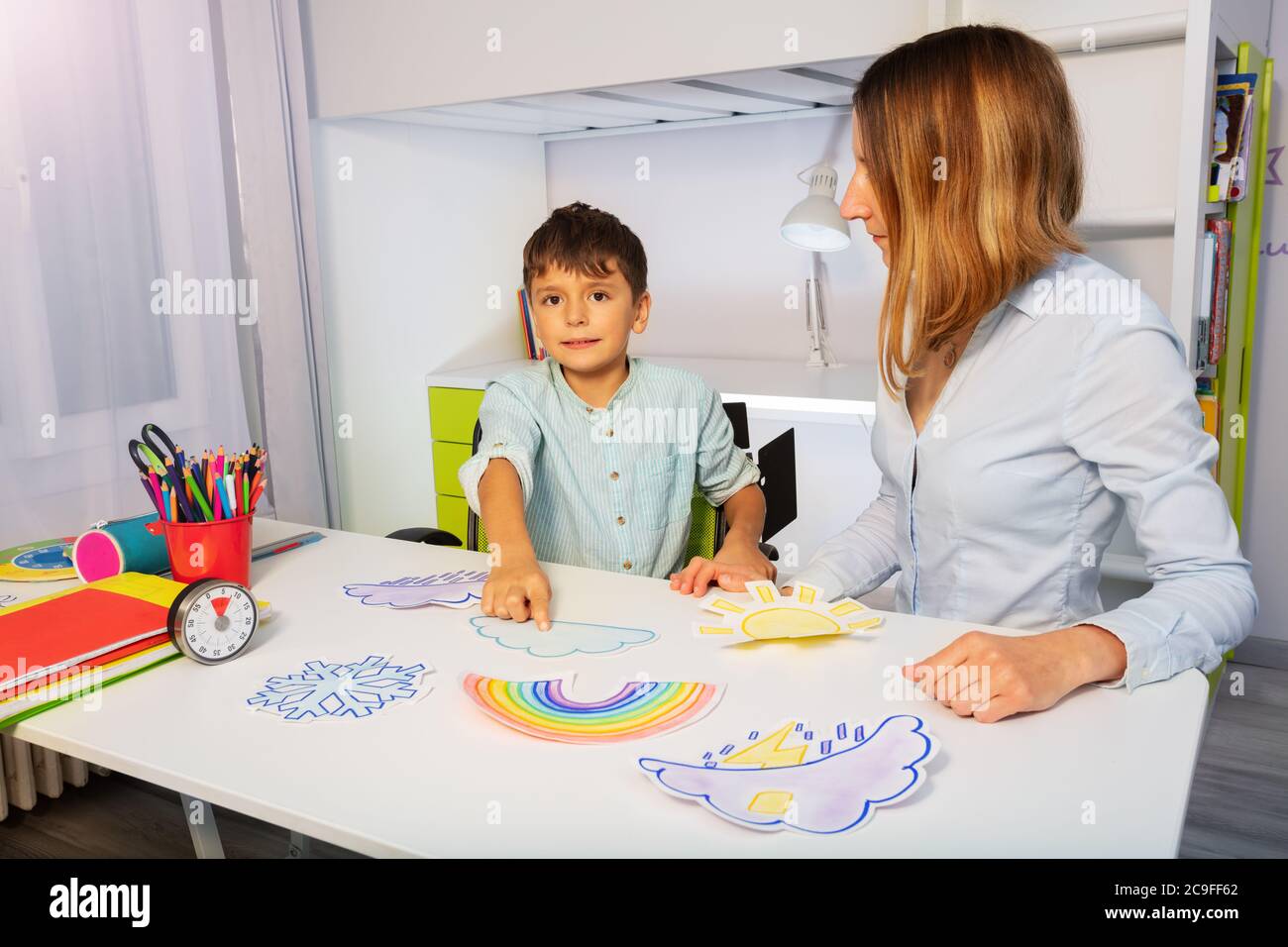 Boy with autism spectrum disorder learn weather using cards, teacher ...