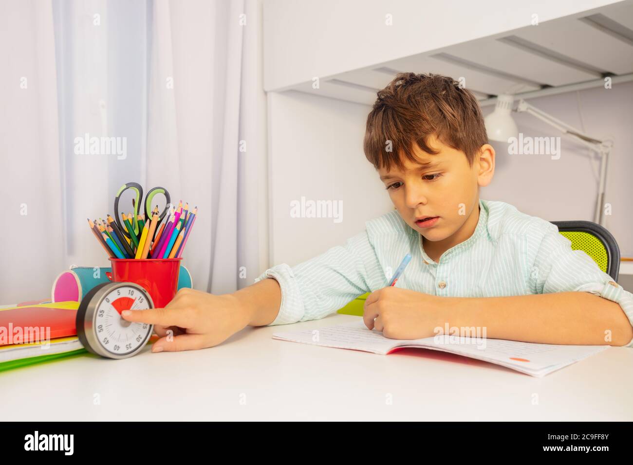 Little boy point to timer during development therapy lesson on ...
