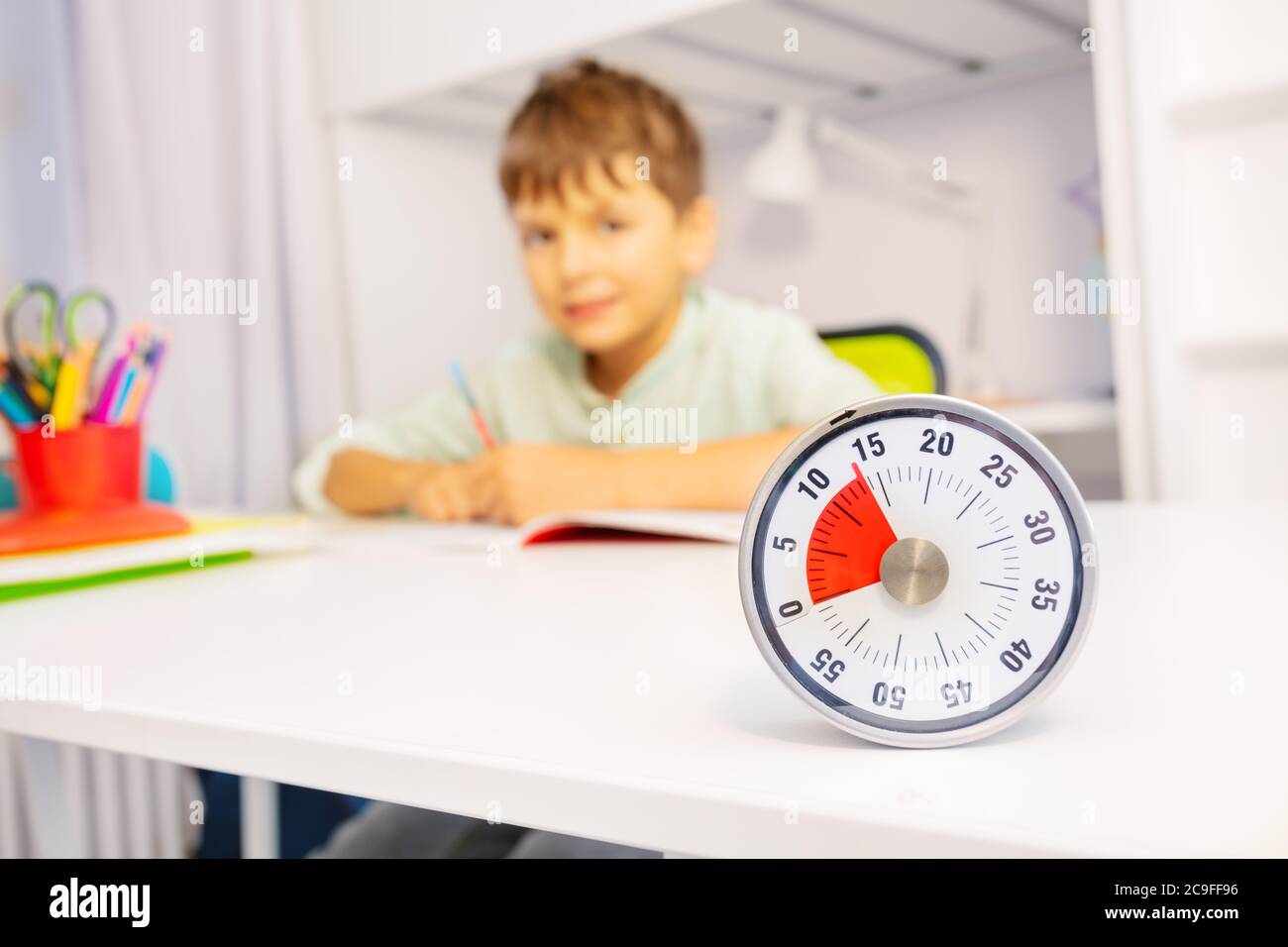 Timer and little boy during development therapy lesson on background ...