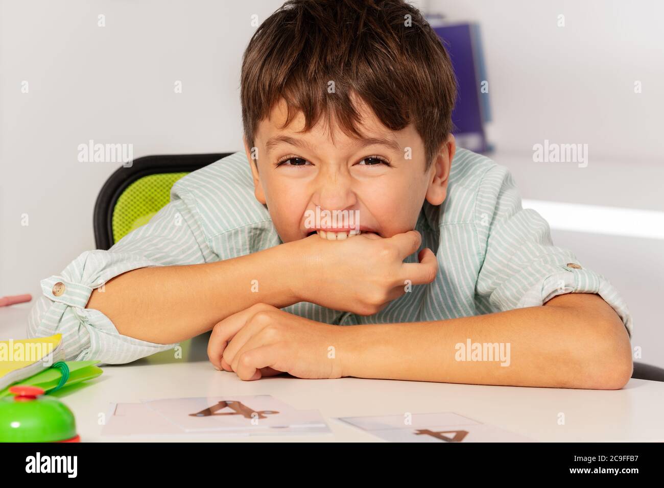 Boy with autism spectrum disorder bite hand and negative expression ...