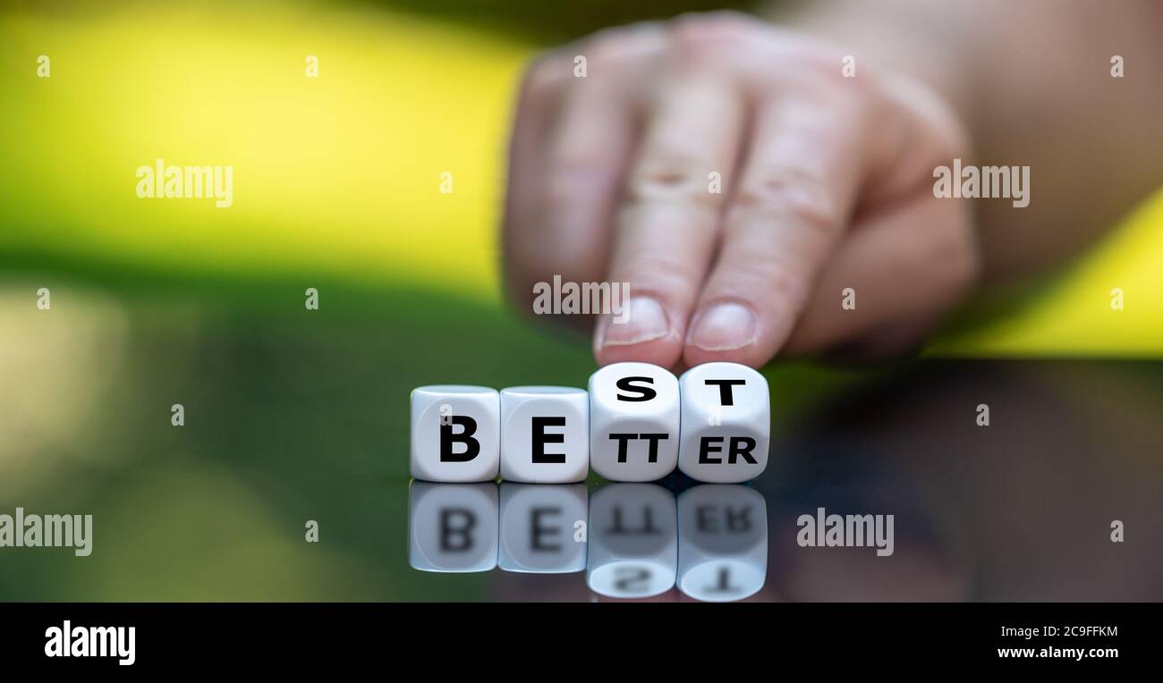 Hand turns dice and changes the word better to best Stock Photo - Alamy
