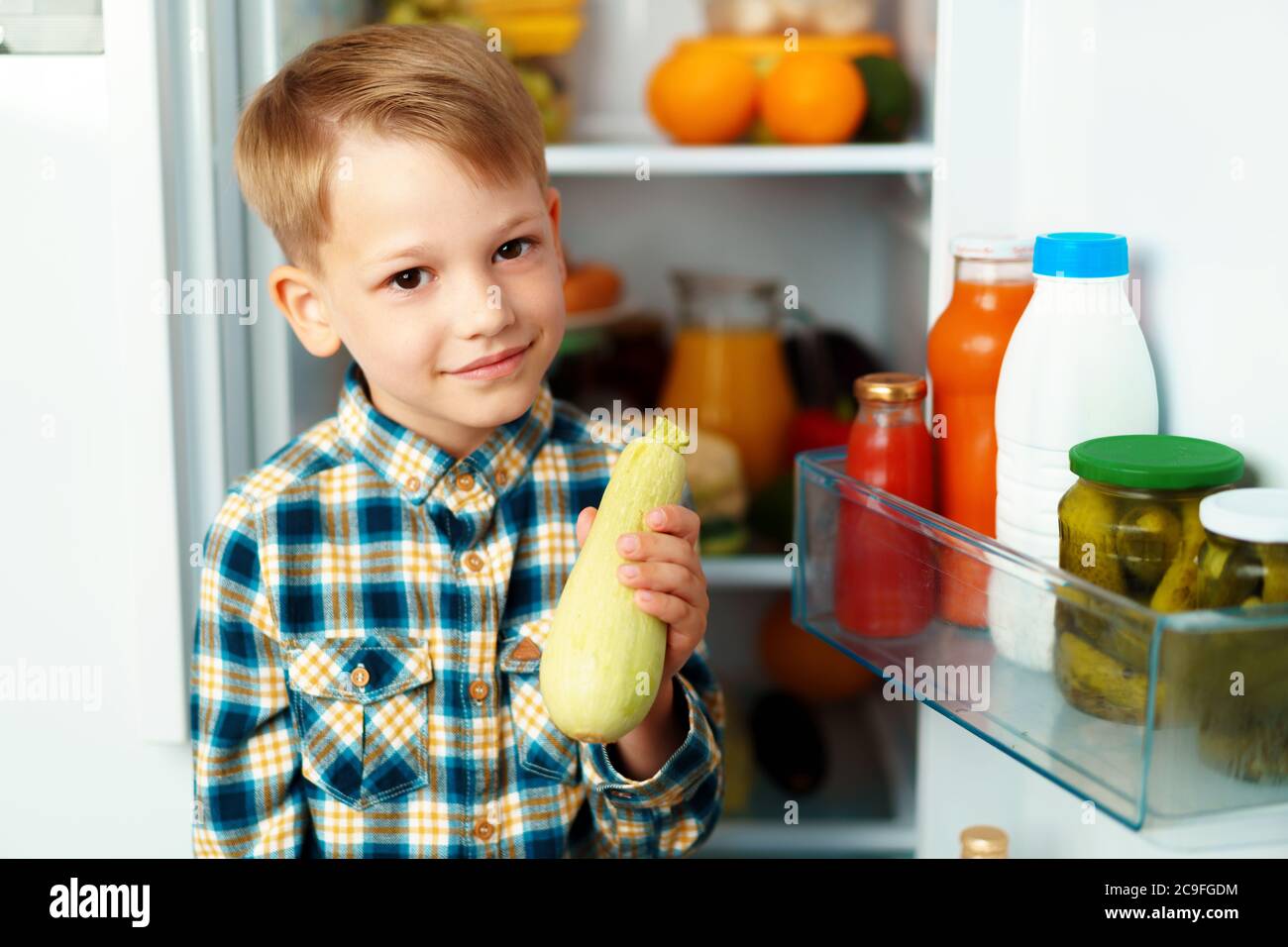 Boy standing in front of open fridge hi-res stock photography and ...