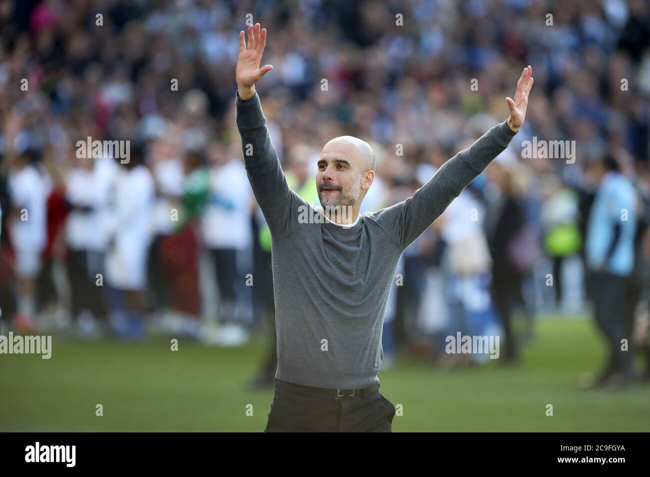 Manchester City manager Pep Guardiola celebrate with fans as part of ...