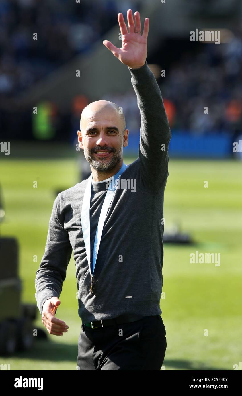 Manchester City manager Pep Guardiola celebrate with fans as part of ...