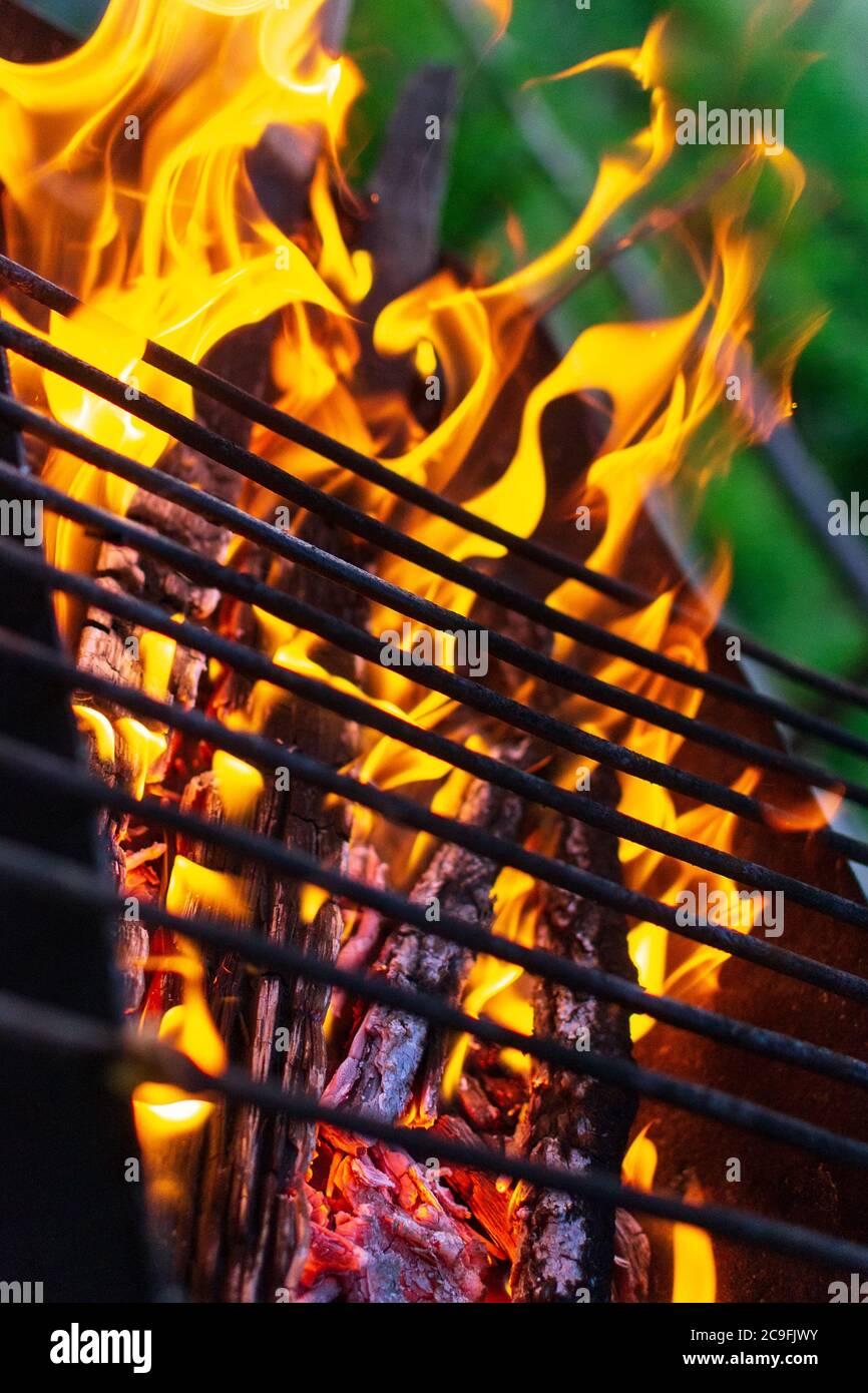 Empty flaming grill with an open fire, ready to place the product ...