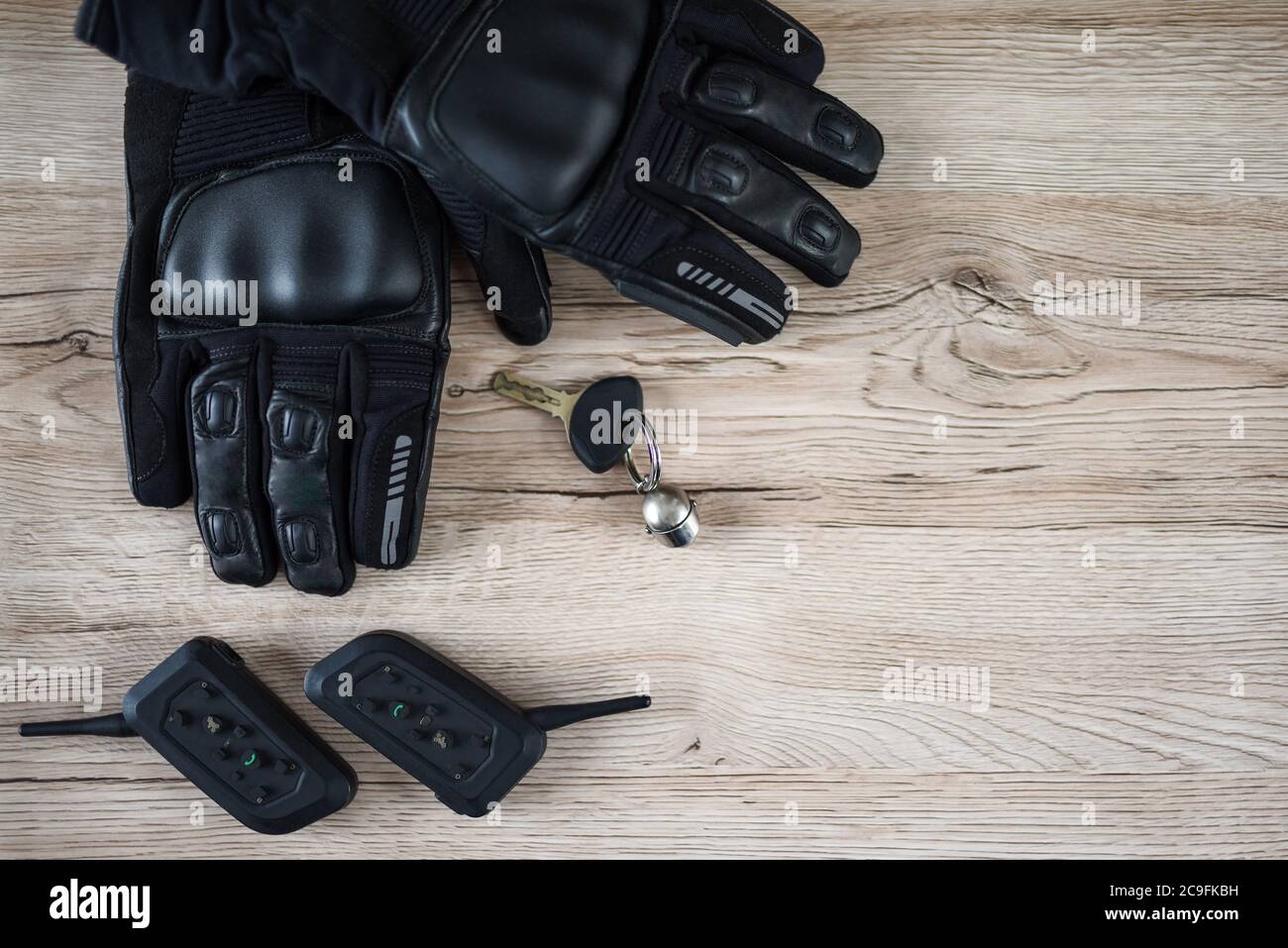 View of motorcycle accessories. Items included motorcycle gloves, keys ...