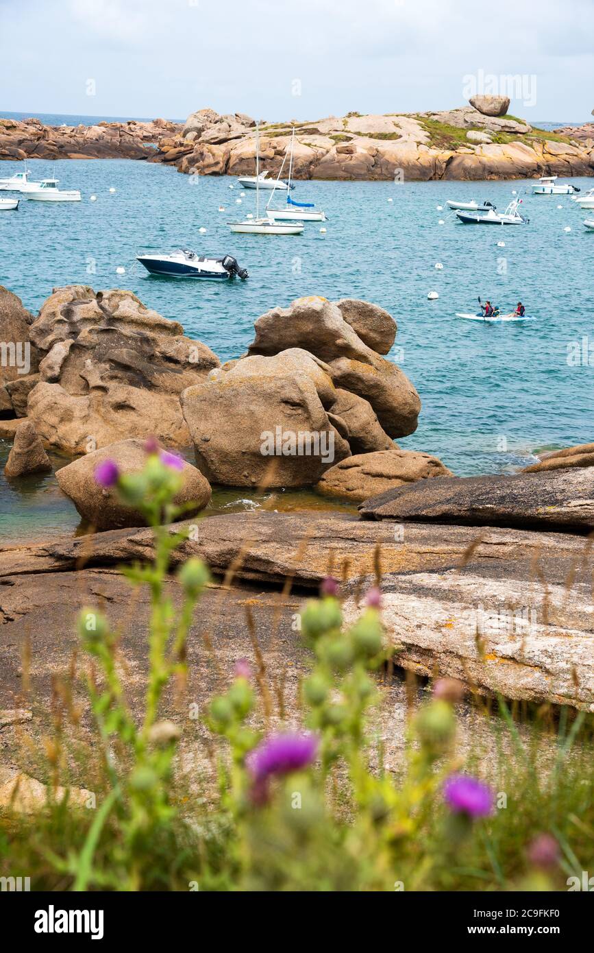 Family kayaking between unique rock formation at and mooring fishing ...