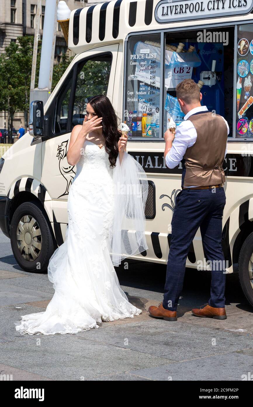 Newly married couple enjoying a 99 ice cream cone on Liverpool seafront ...