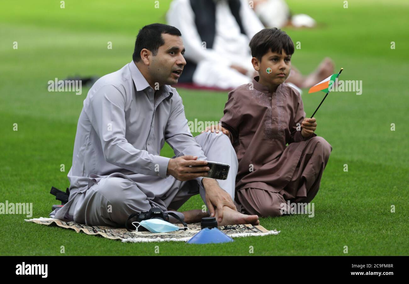 Kamil Ayub (right), aged 6, holds an Irish flag alongside his father ...