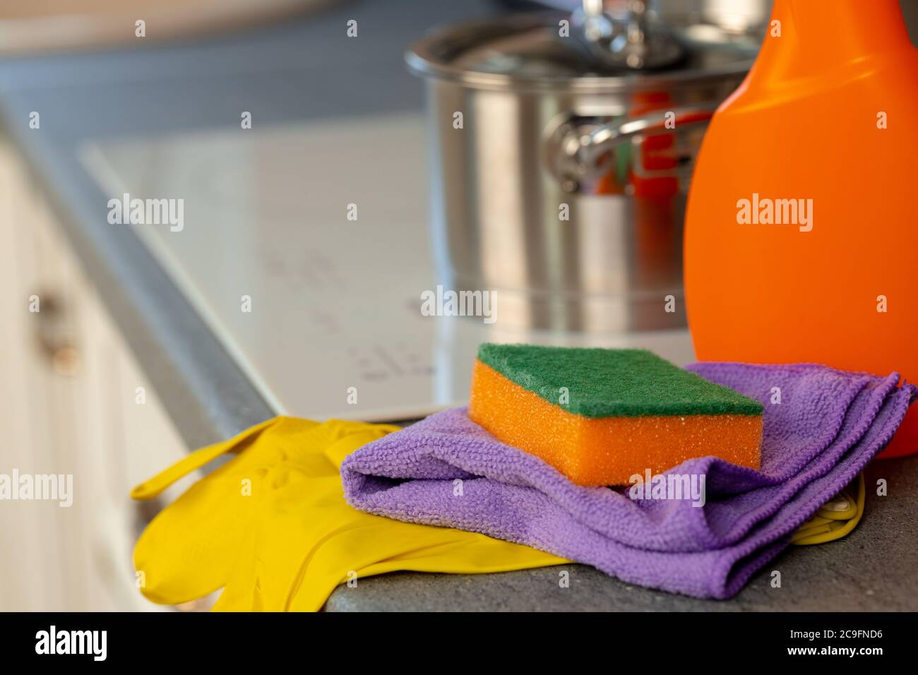 Cleaning detergents and tools on a kitchen counter Stock Photo - Alamy