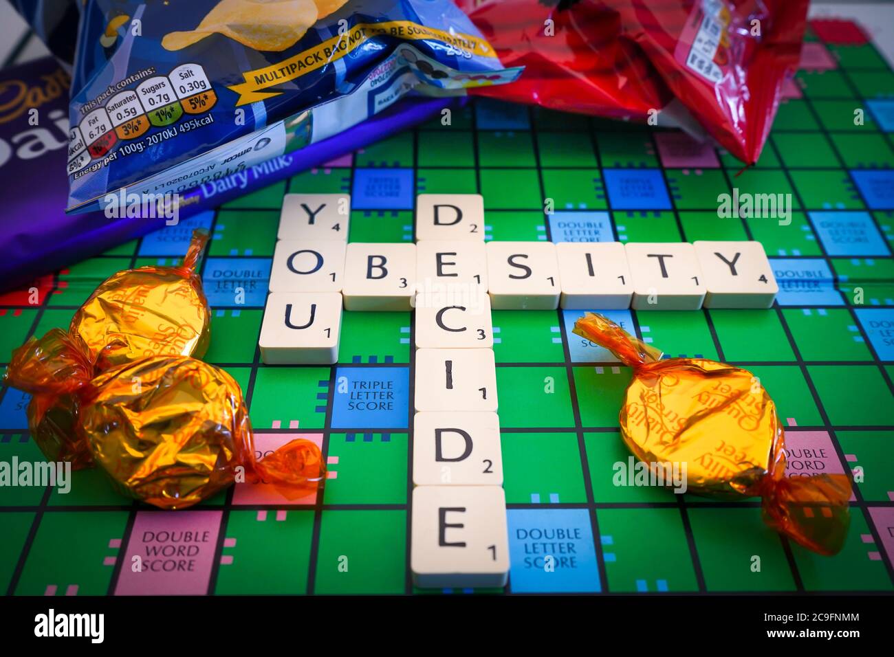 Close up of Scrabble game letters spelling words: obesity you decide on ...