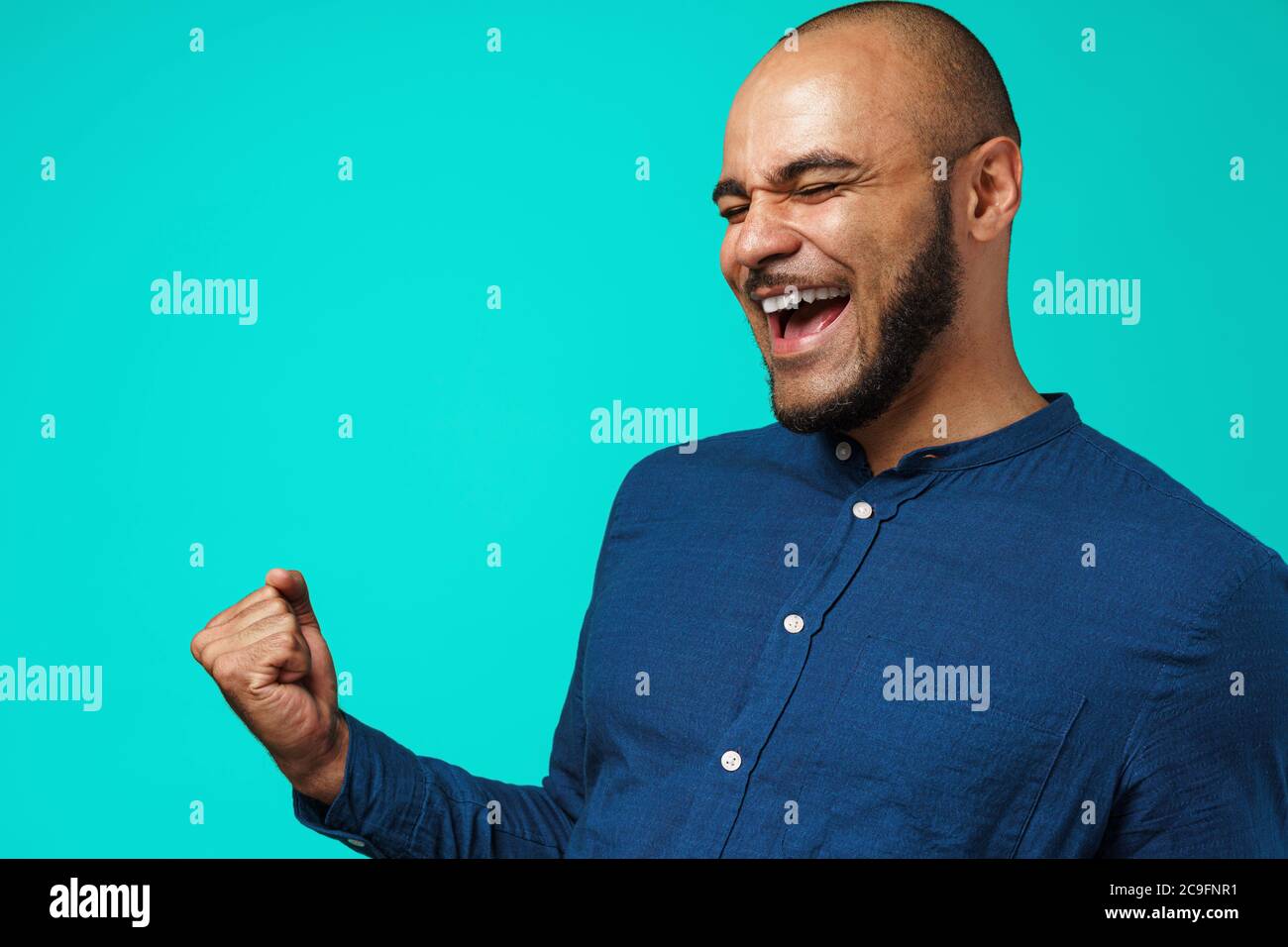 Portrait of a happy black man celebrating his success expressing joy ...