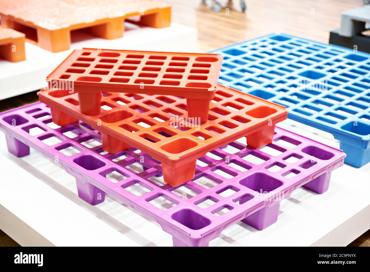 Plastic colored pallets at the trade show Stock Photo - Alamy