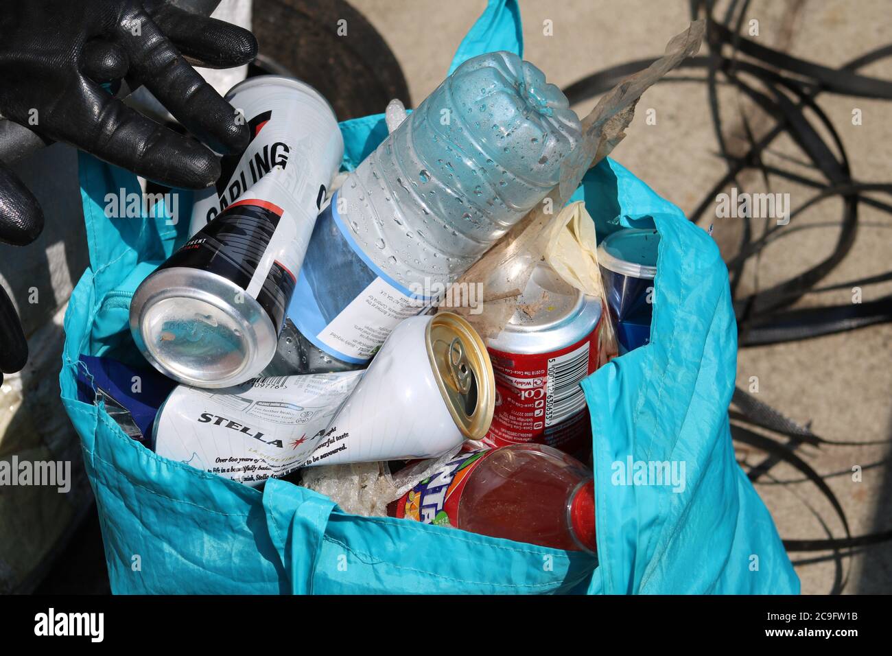 Plastic bag cans thrown away hi-res stock photography and images - Alamy