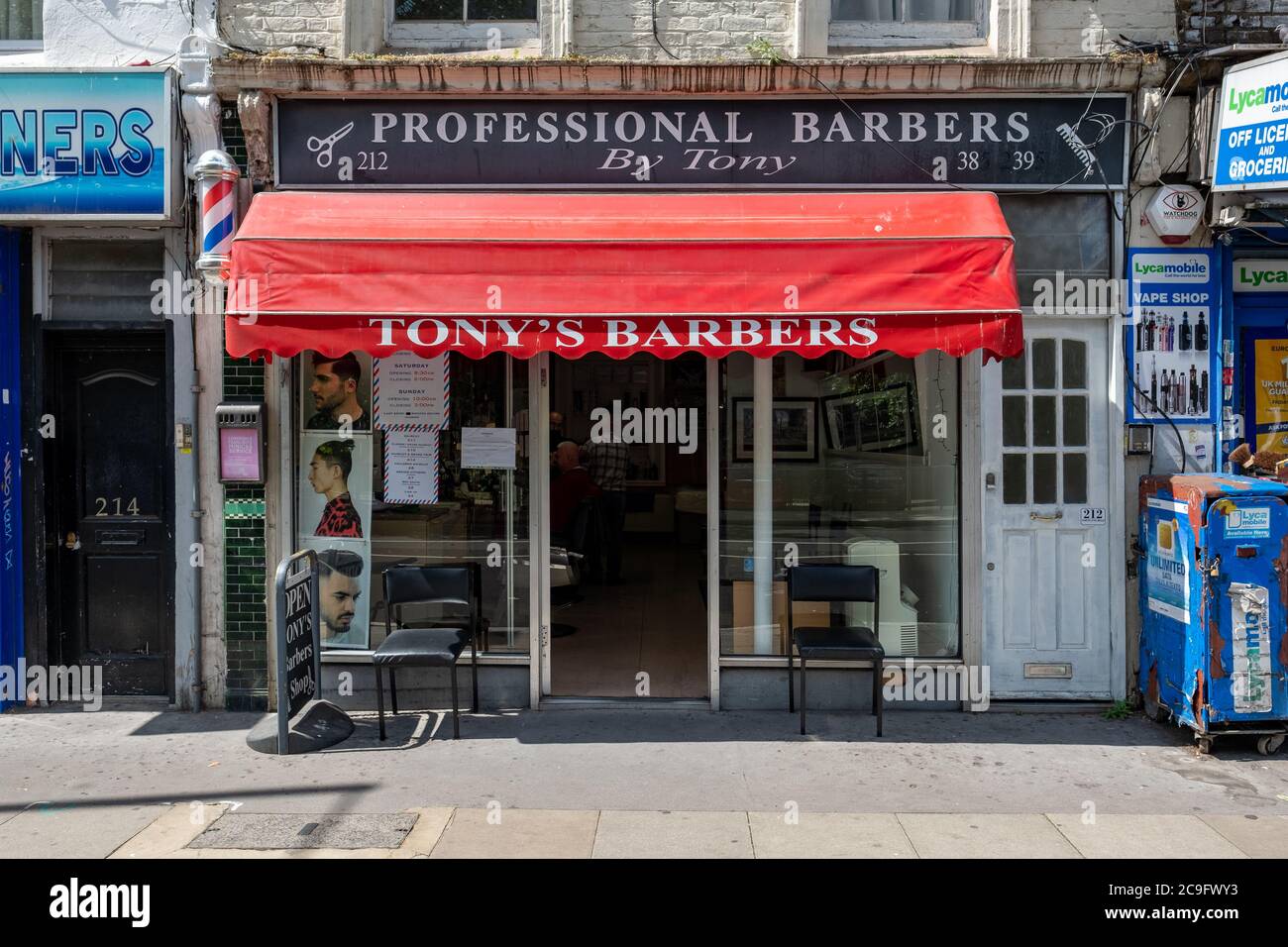 London- July, 2020: A barber shop on London high street, a typical ...