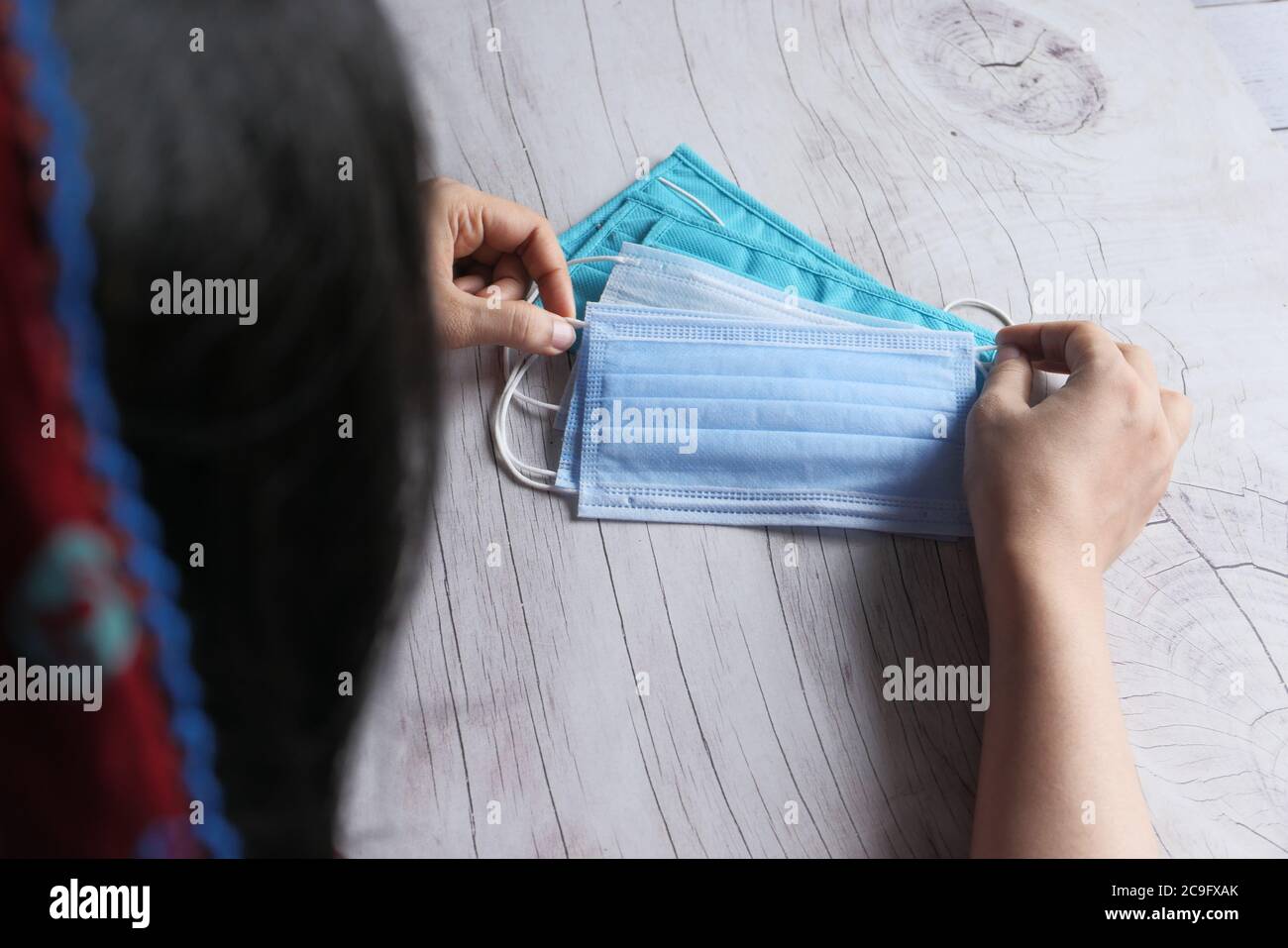 rear view of women holding protective face mask Stock Photo - Alamy