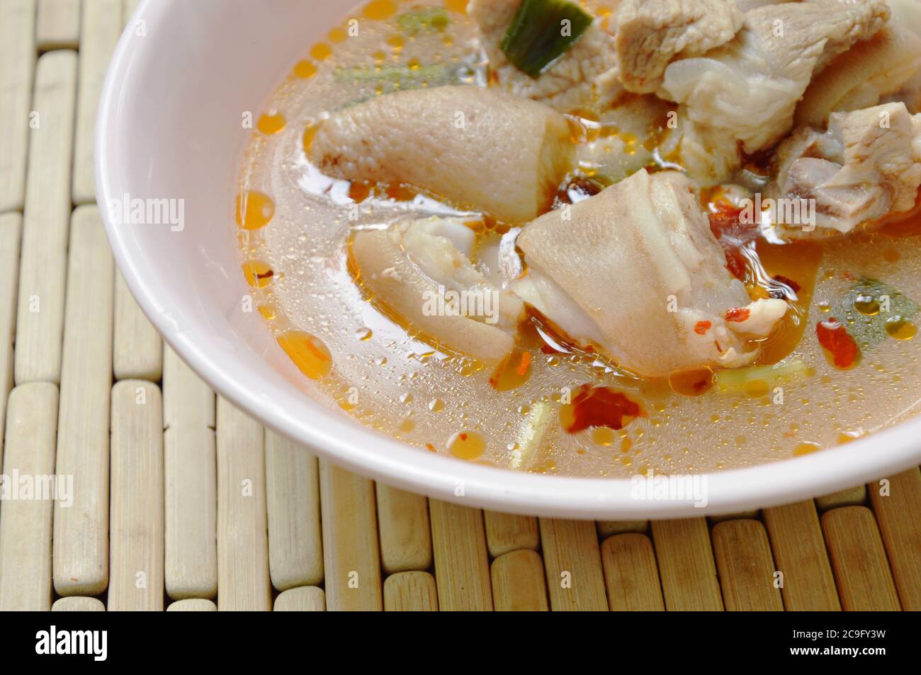 spicy boiled pork leg in Tom Yum soup on bowl Stock Photo - Alamy