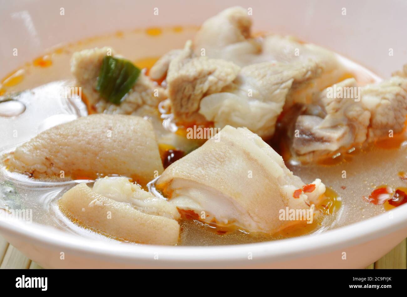 spicy boiled pork leg in Tom Yum soup on bowl Stock Photo - Alamy