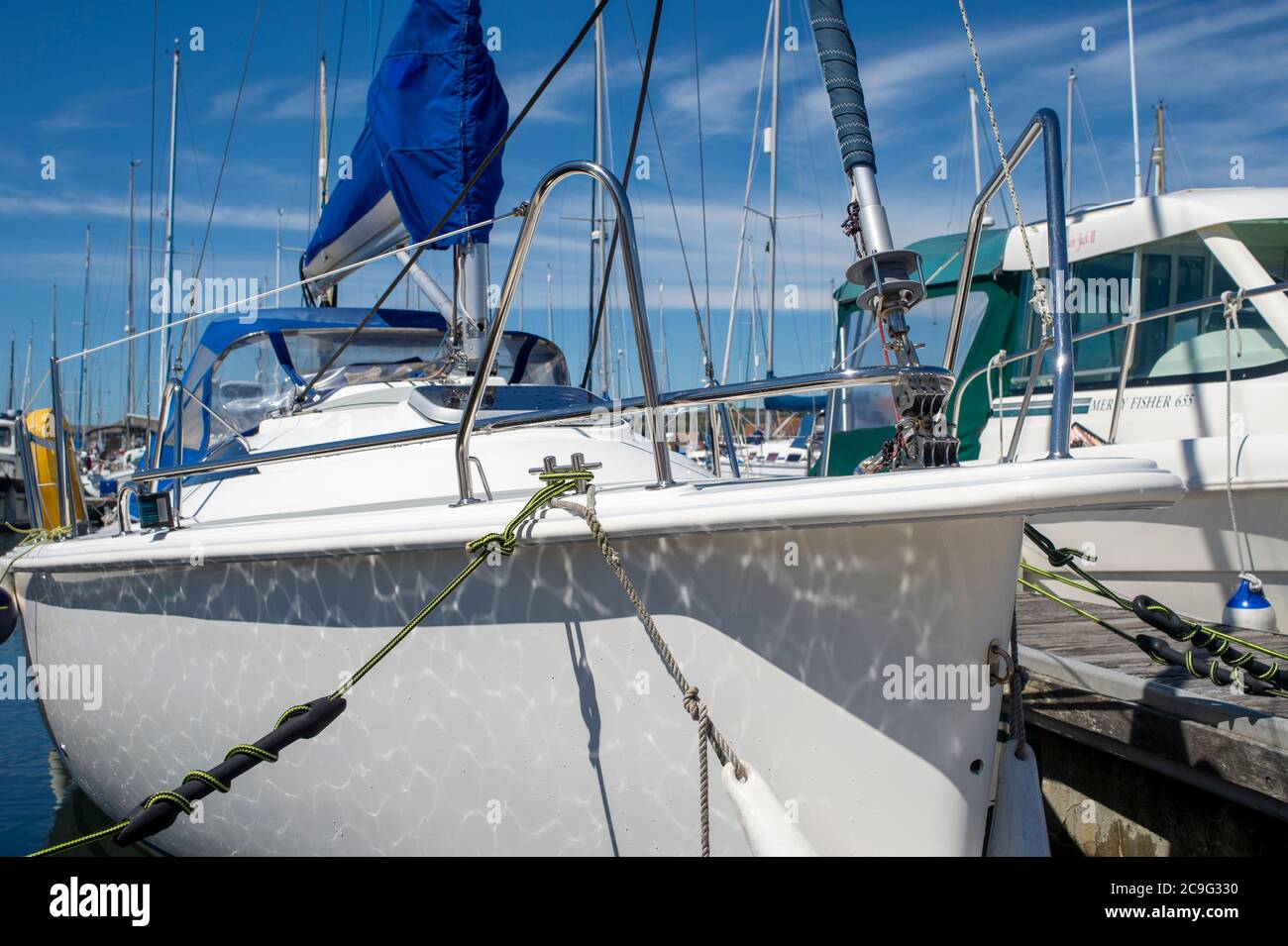 Bow of a sailing yacht moored in a marina. Ropes and sails Stock Photo ...