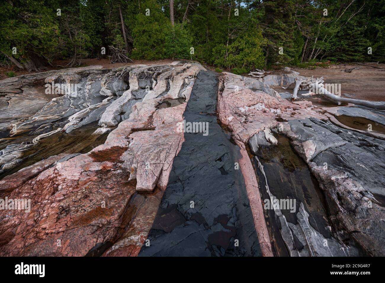 Pink and white granite mixed alongside basalt flowed and created a ...