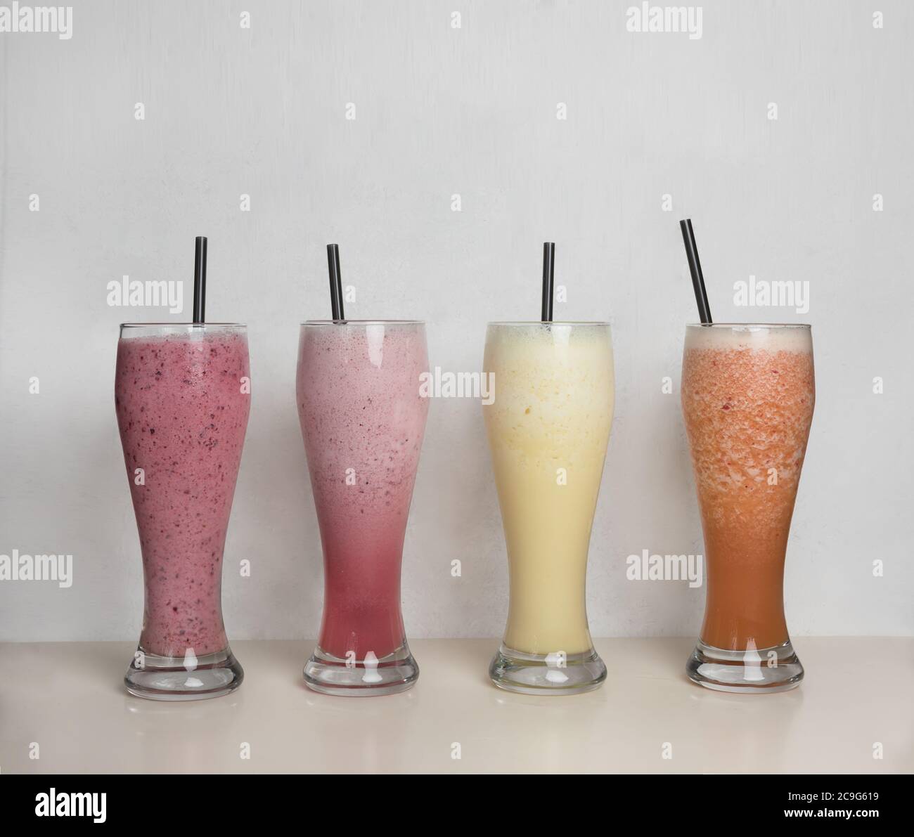 Fruit milky cocktails on a isolated white background Stock Photo - Alamy