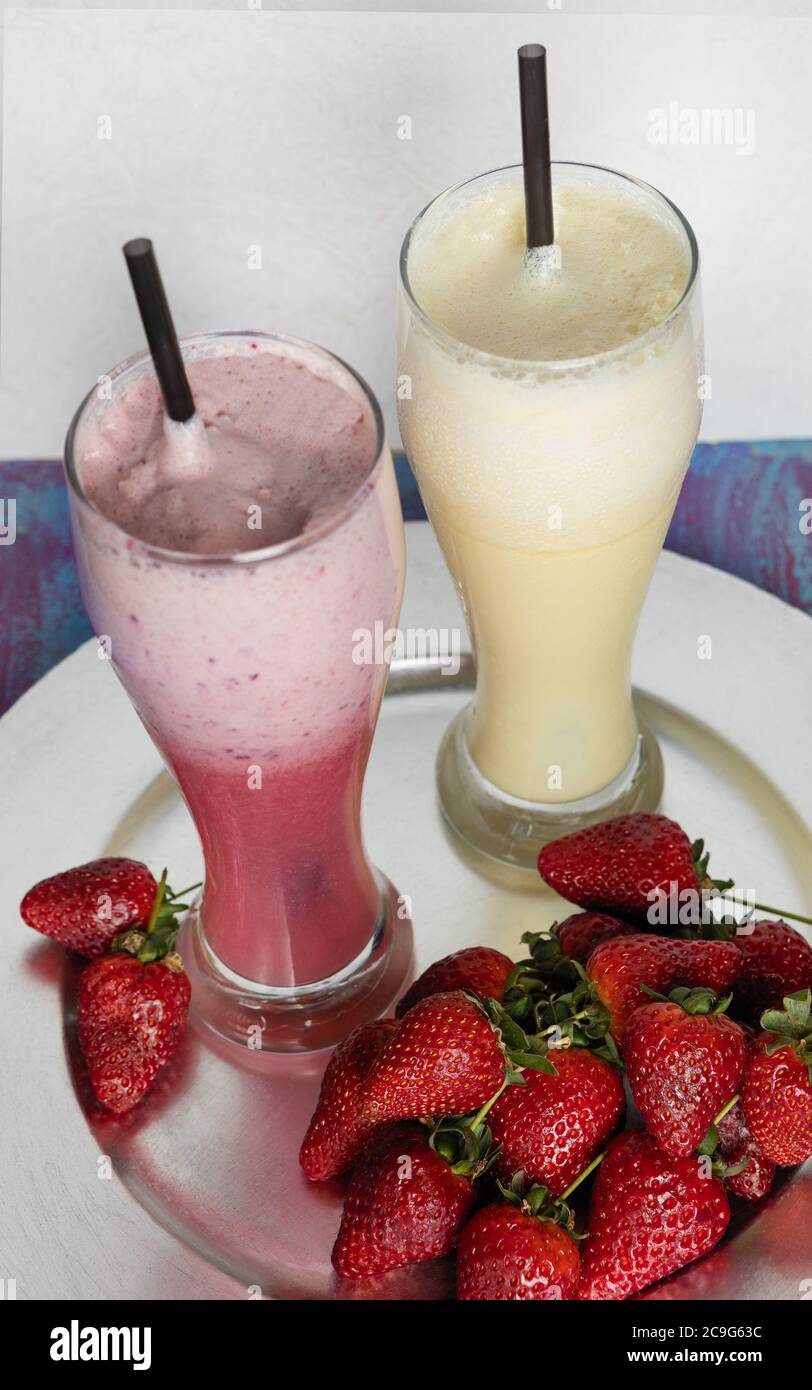 Fruit milky cocktails with strawberry on a white pot Stock Photo - Alamy