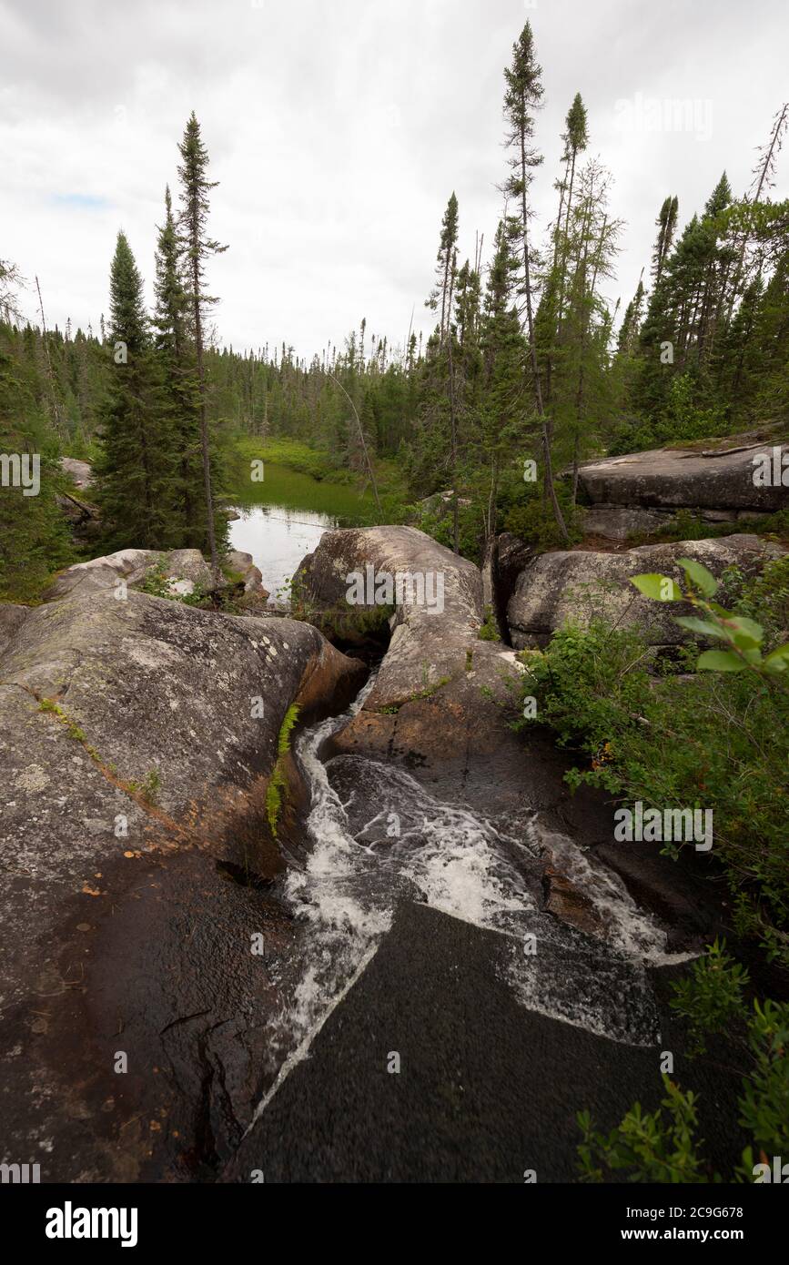 A stream had worn a curvy channel through bedrock on its way down to a ...