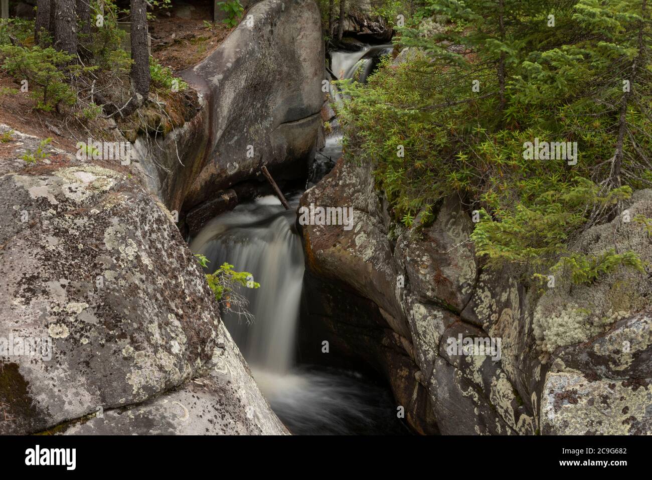 A stream had worn a curvy channel through bedrock on its way down to a ...