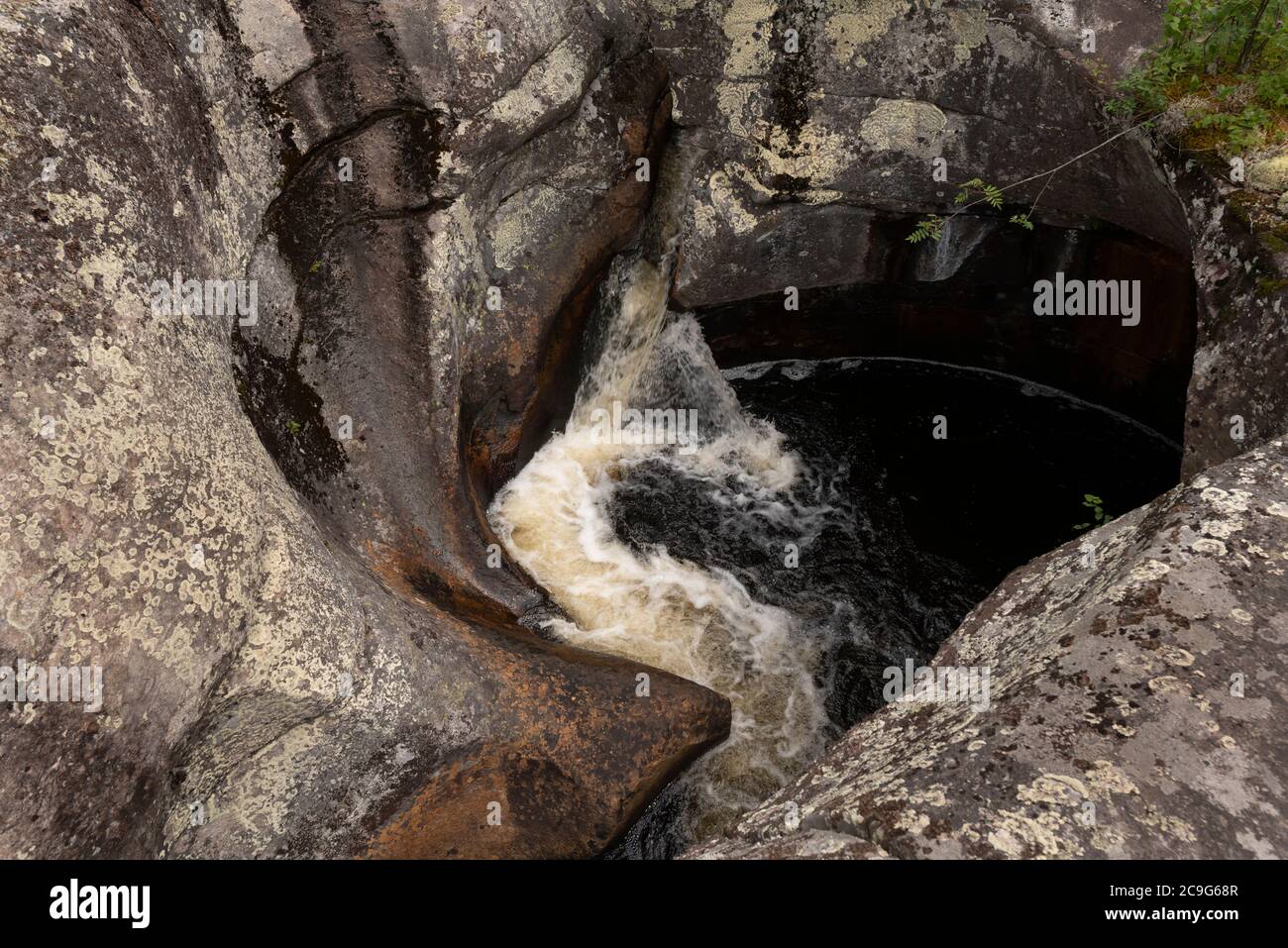 A stream had worn a curvy channel through bedrock on its way down to a ...