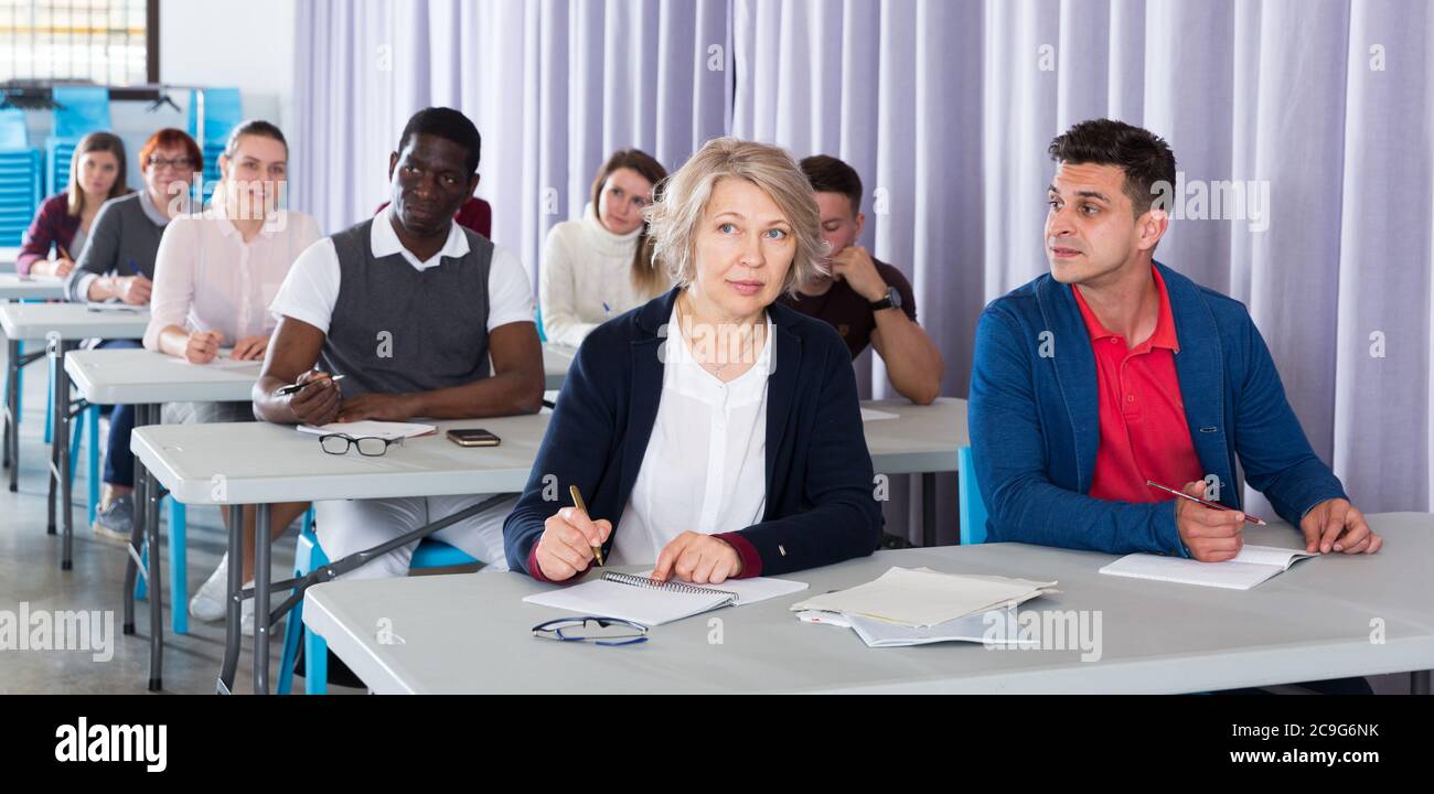 Multinational group of different age students at extension courses ...