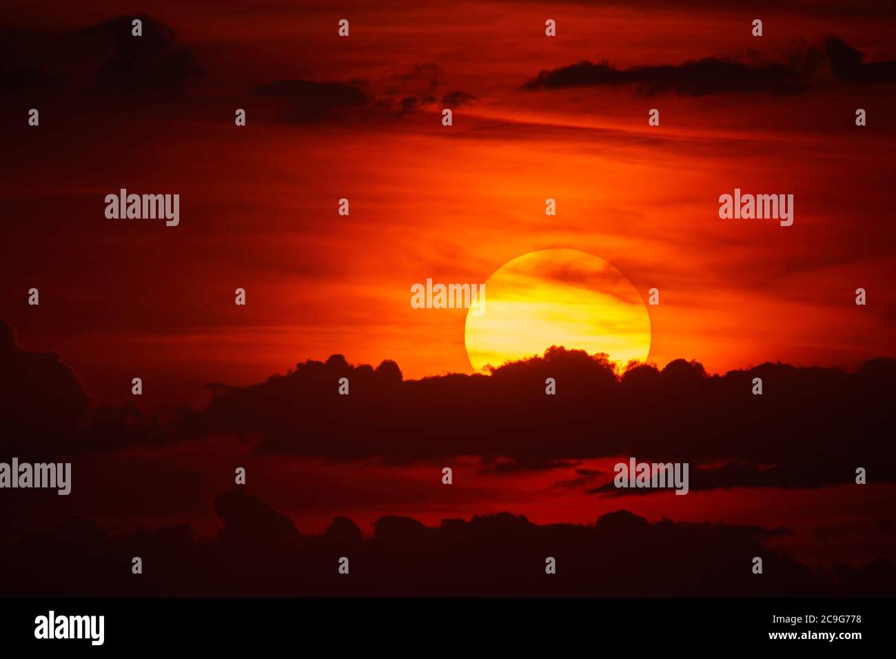 Big red sun setting through hi-res stock photography and images - Alamy