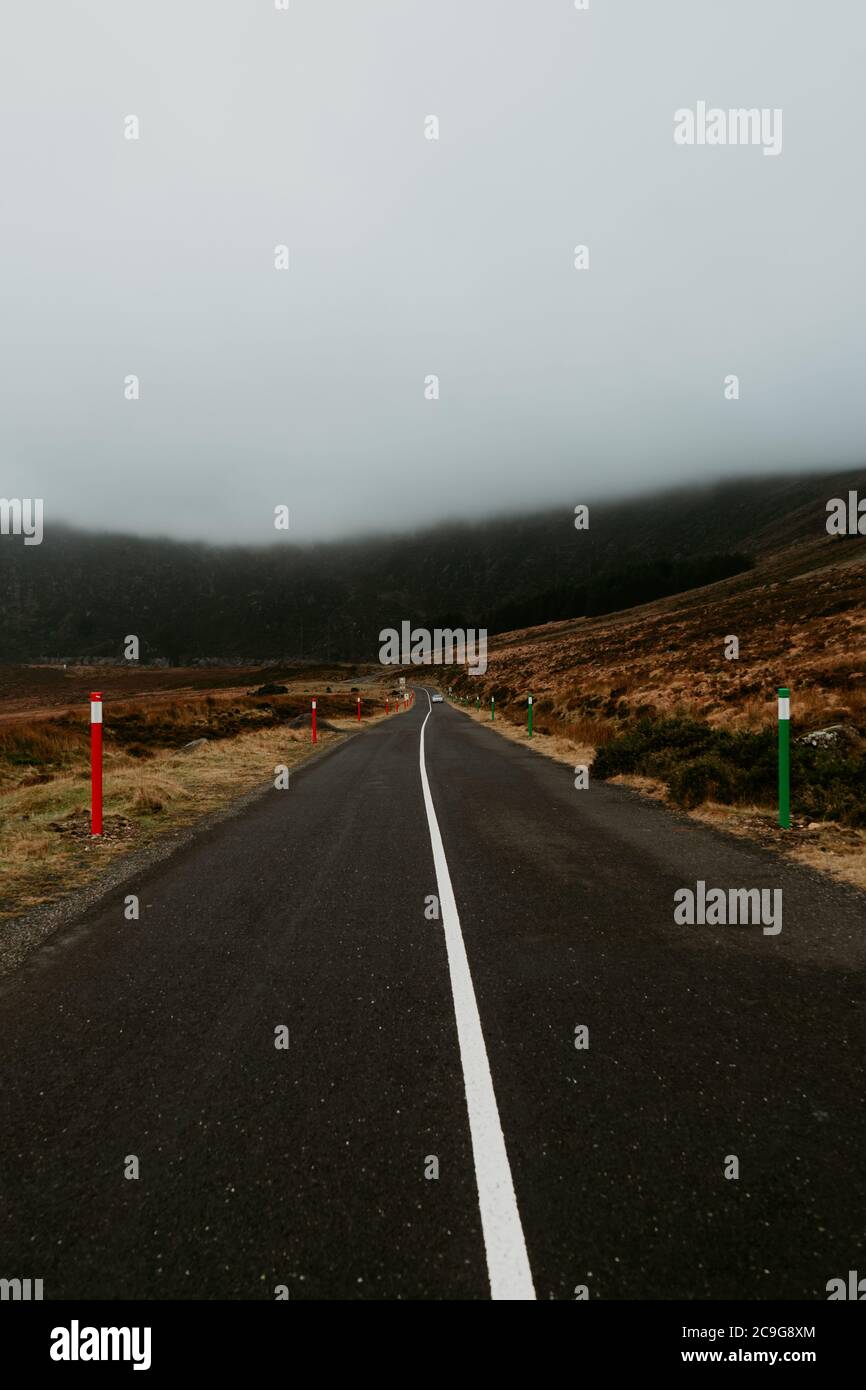 Green and red markers line a road along the wild atlantic way route ...