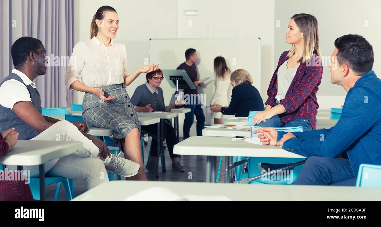 Positive adult students communicating during recess between lectures in ...