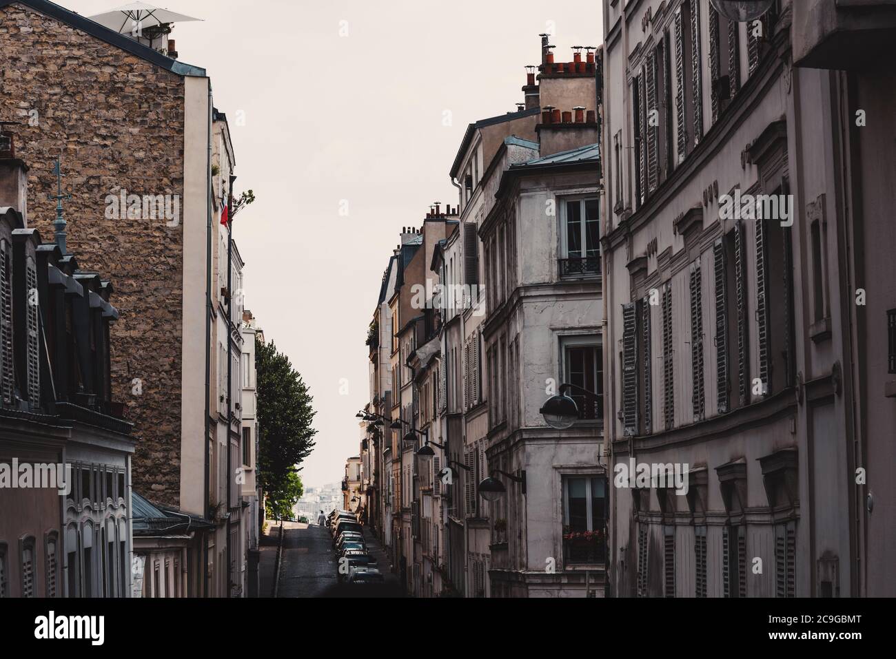 Narrow street and tall buildings in Montmartre. Paris, France Stock ...