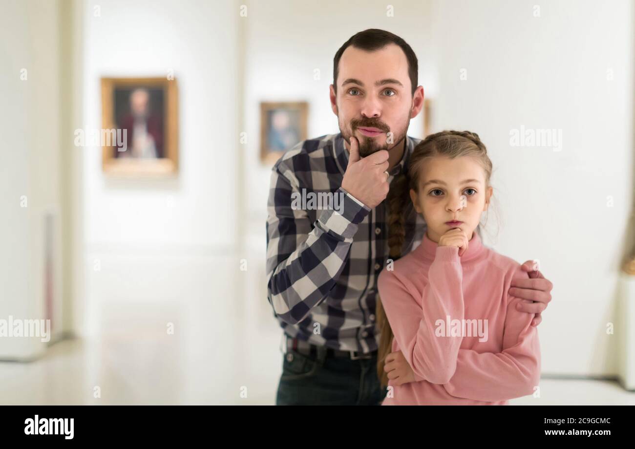 young spanish father and daughter looking at paintings in halls of ...