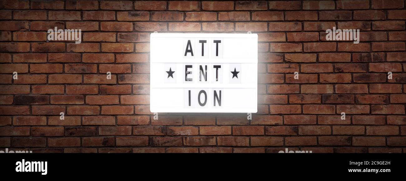 attention letterboard text - background with copy space on red bricks ...