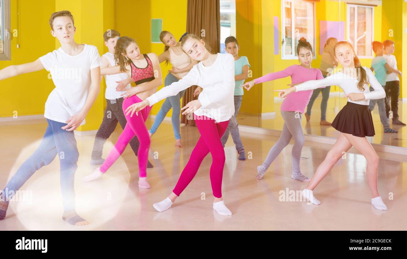 Group of tweens training movements of modern dance in choreography ...